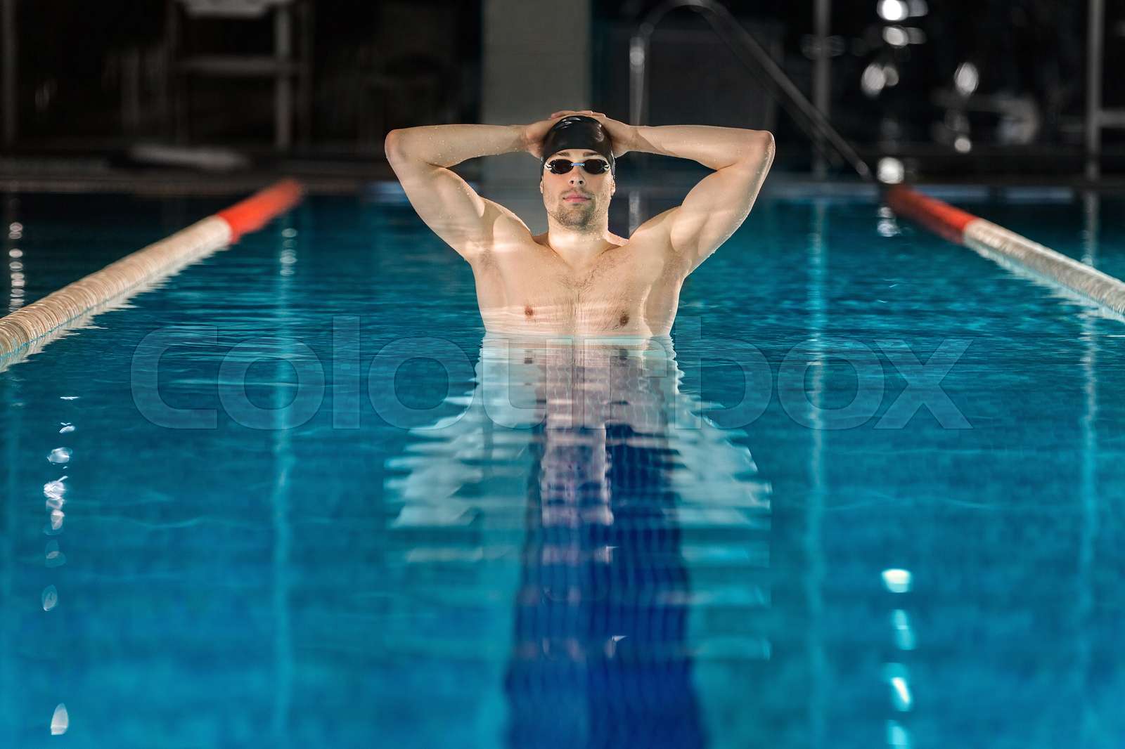 Male swimmer standing in pool | Stock image | Colourbox