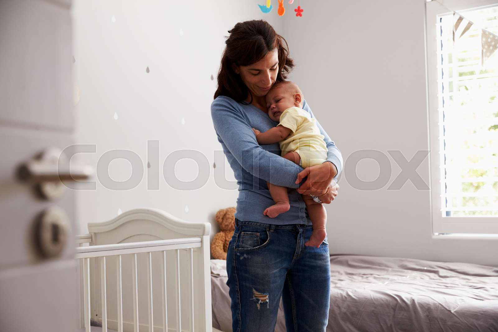 Mother Comforting Newborn Baby Son In Nursery | Stock image | Colourbox