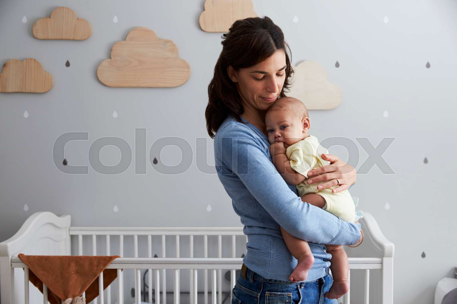 Mother Comforting Newborn Baby Son In Nursery | Stock image | Colourbox