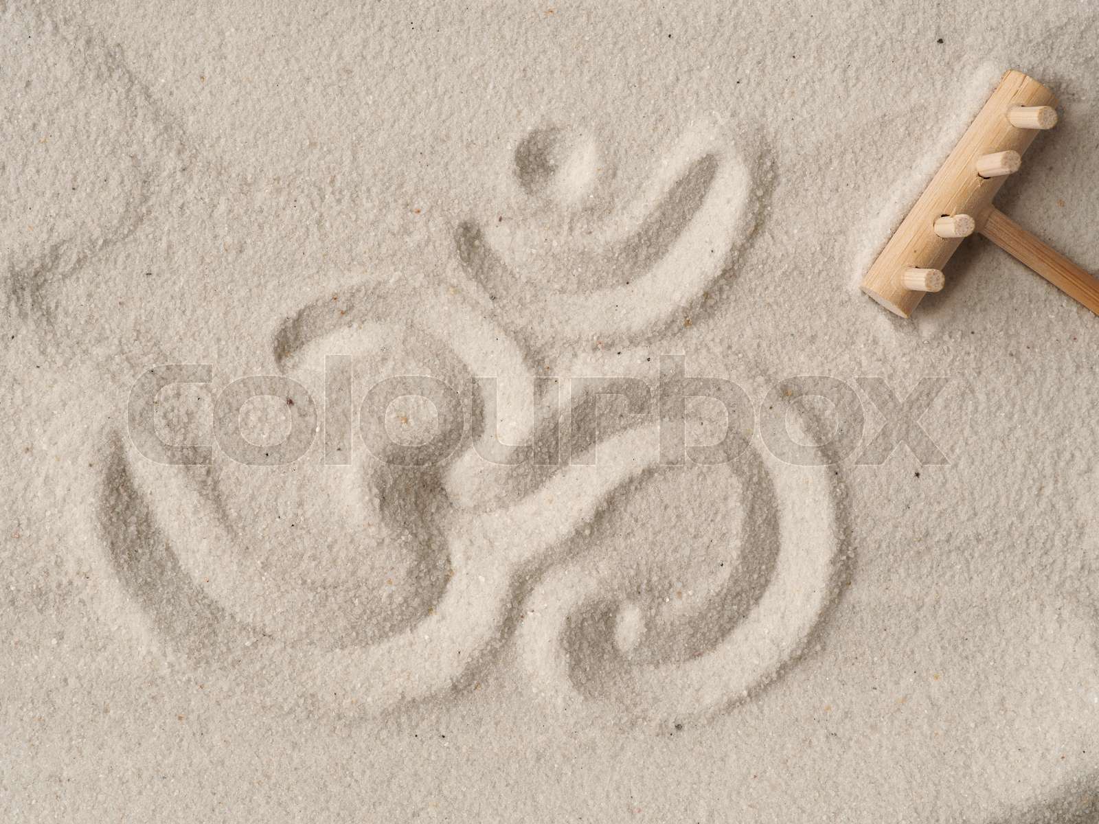 Om symbol in sand | Stock image | Colourbox