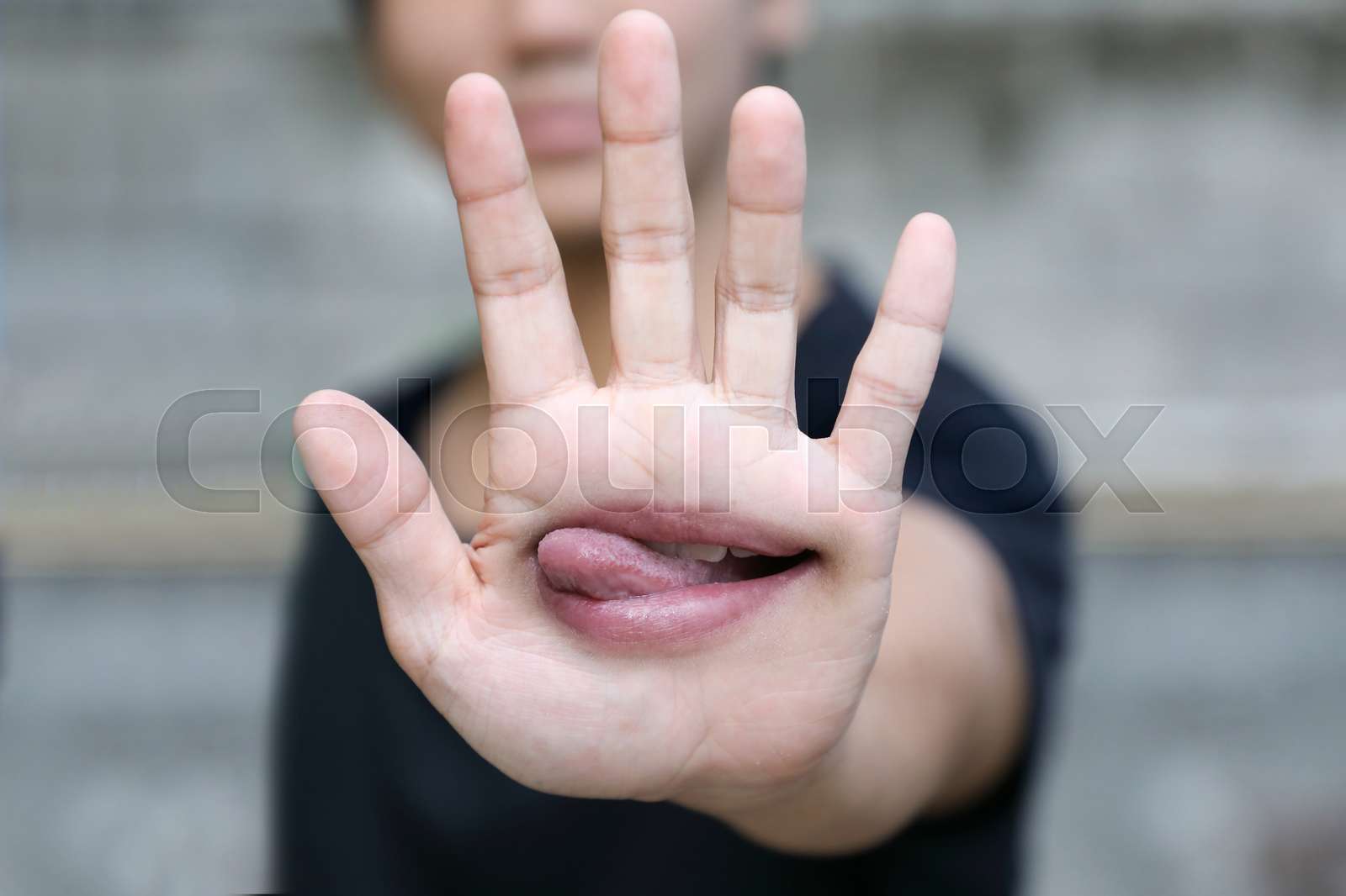 hand showing stop gesture with a mouth on his hand | Stock image ...