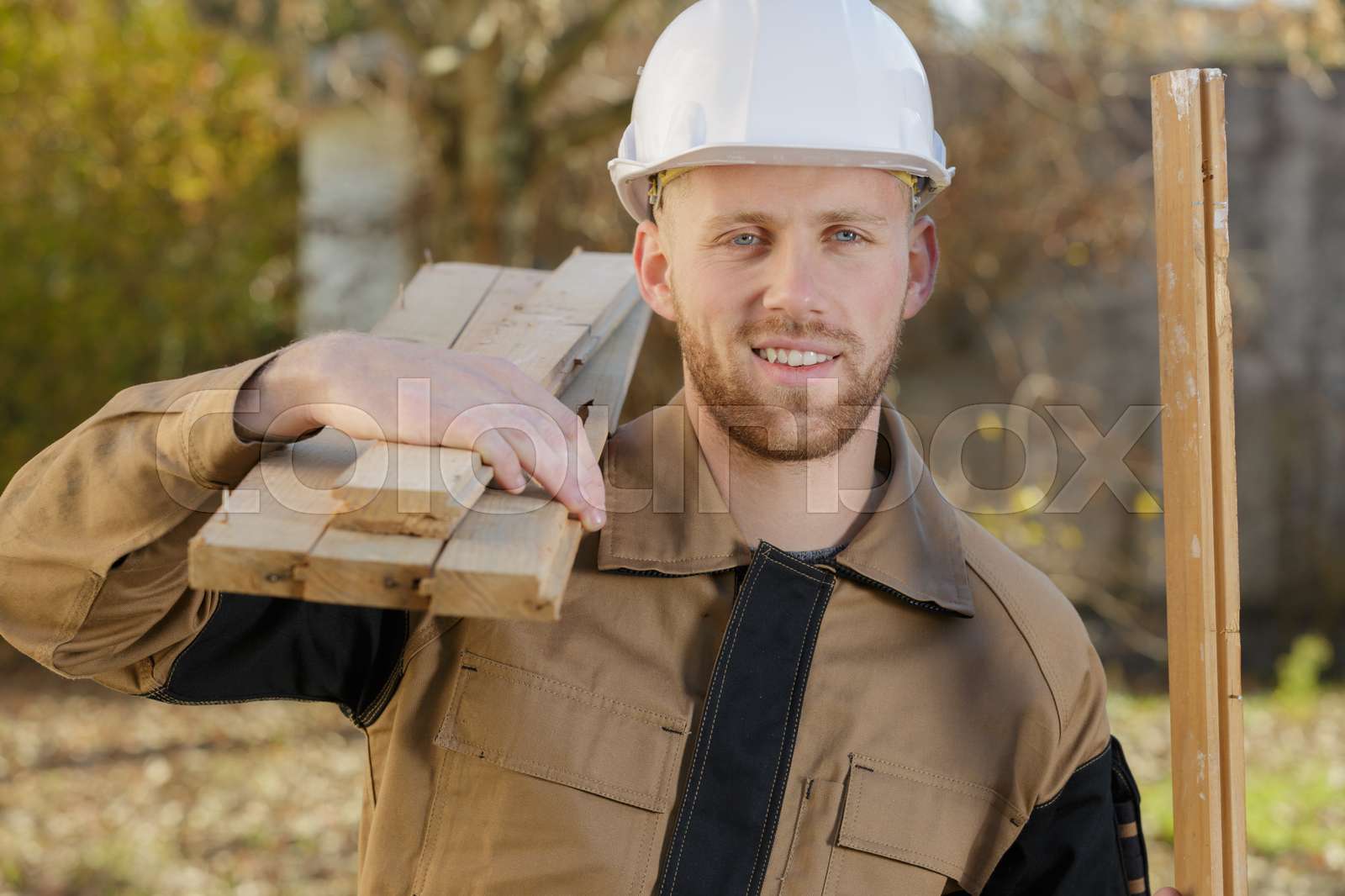 man carrying lumber | Stock image | Colourbox