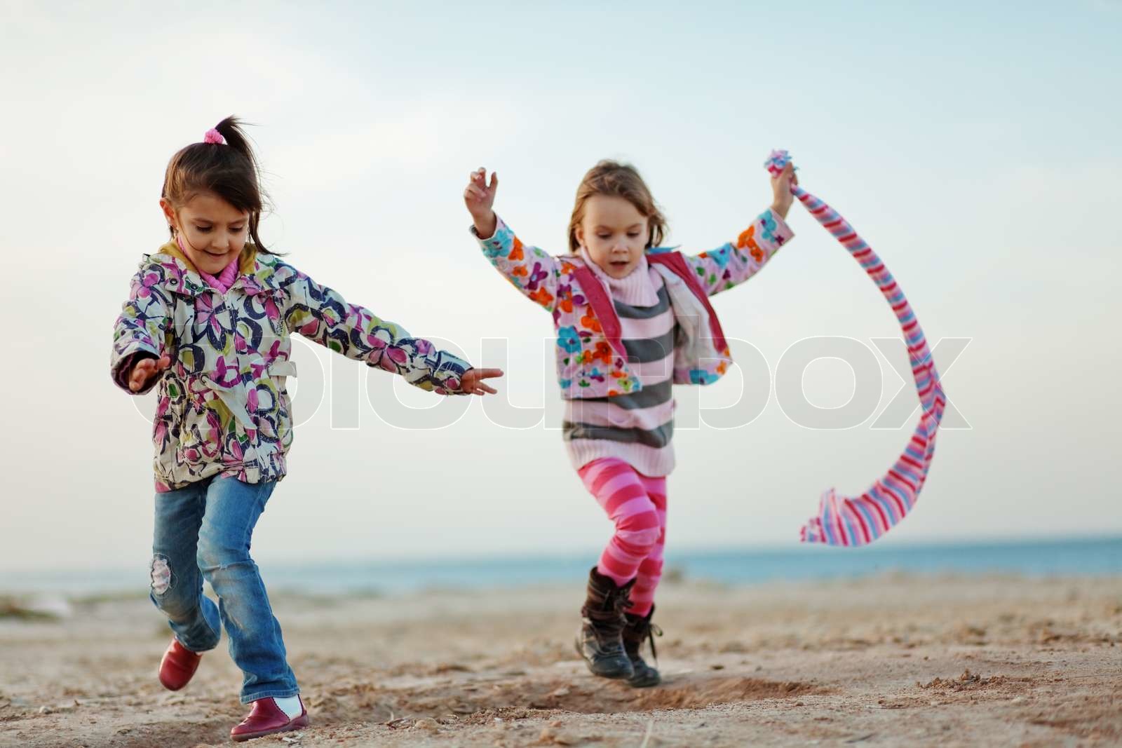Kids playing with sand at the beach | Stock image | Colourbox
