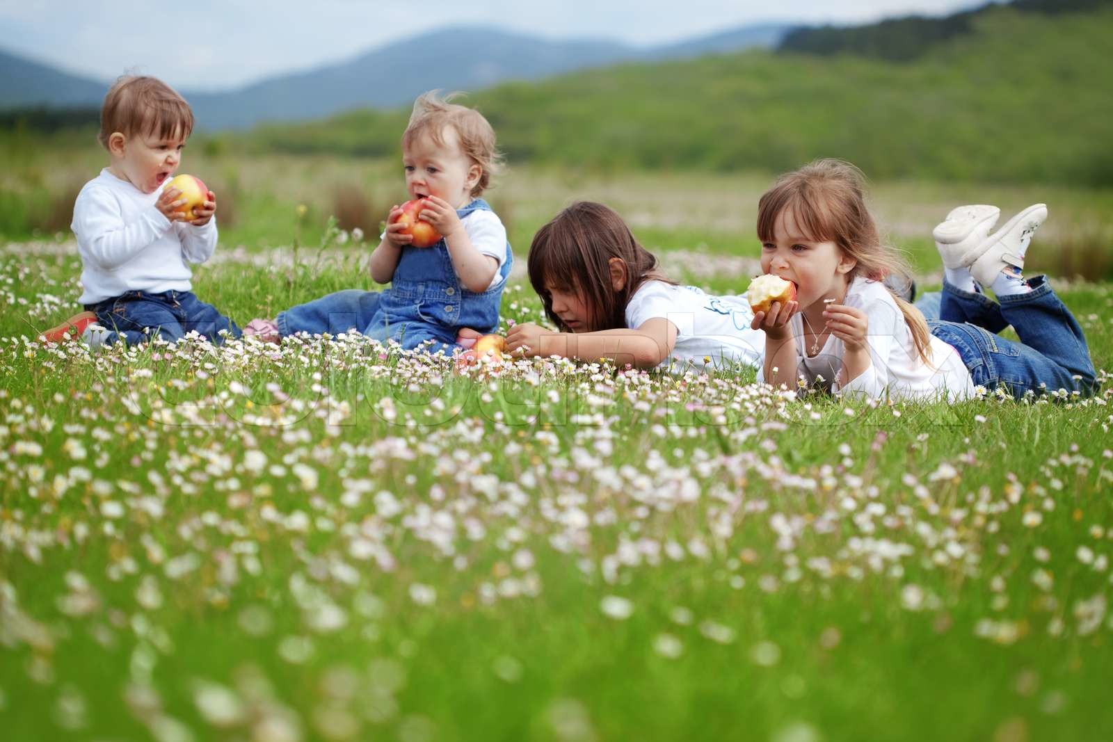 Cute happy children playing in spring filed | Stock image | Colourbox