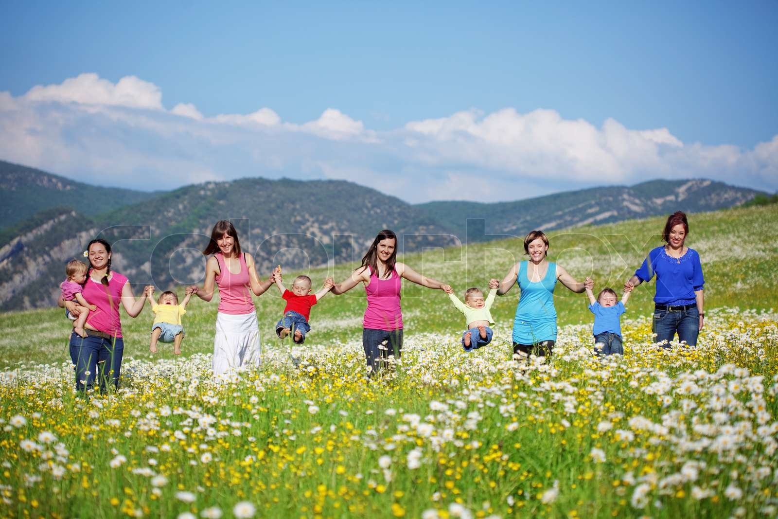 Mothers with children in flower field | Stock image | Colourbox