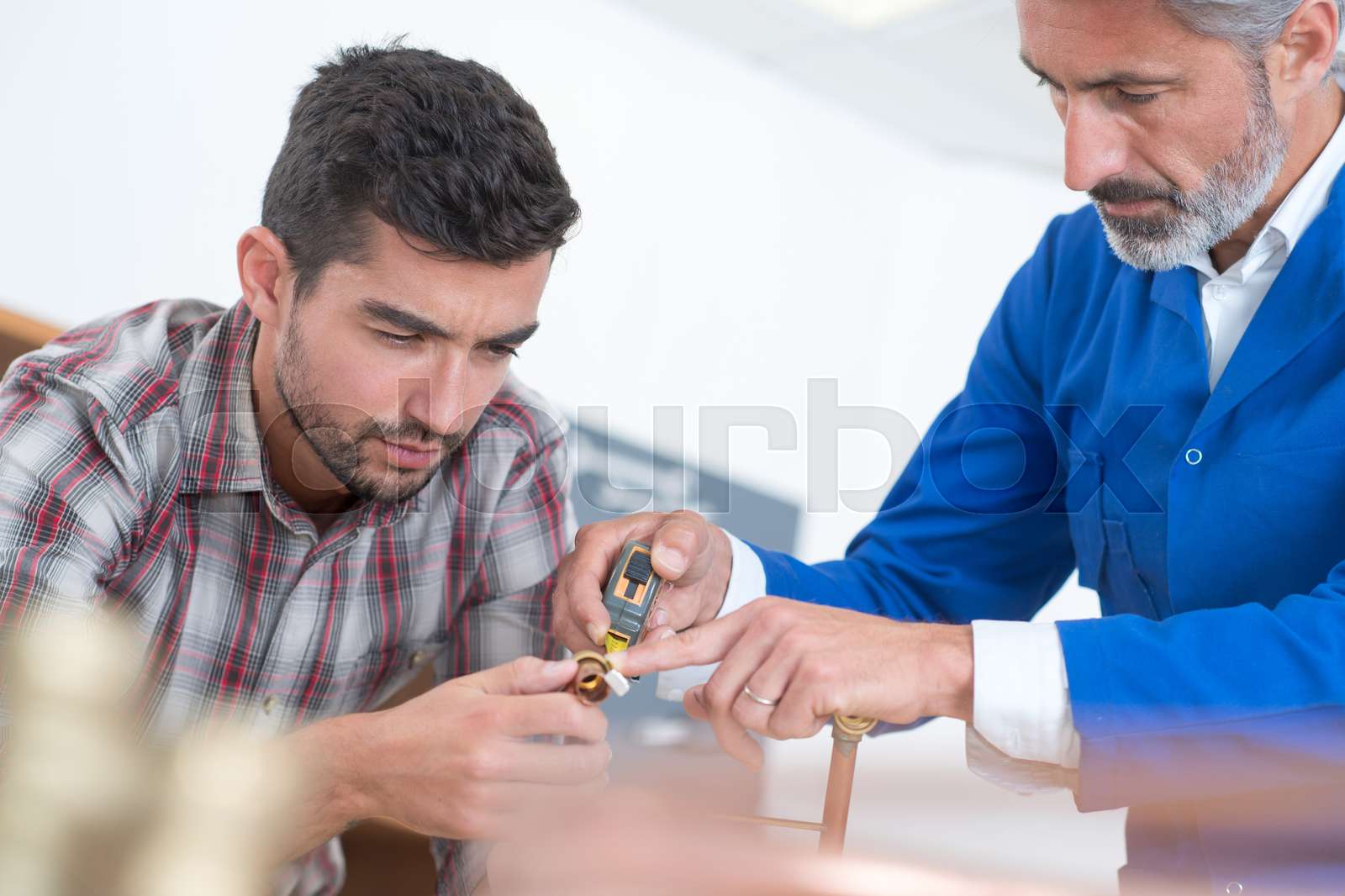 men fixing something | Stock image | Colourbox