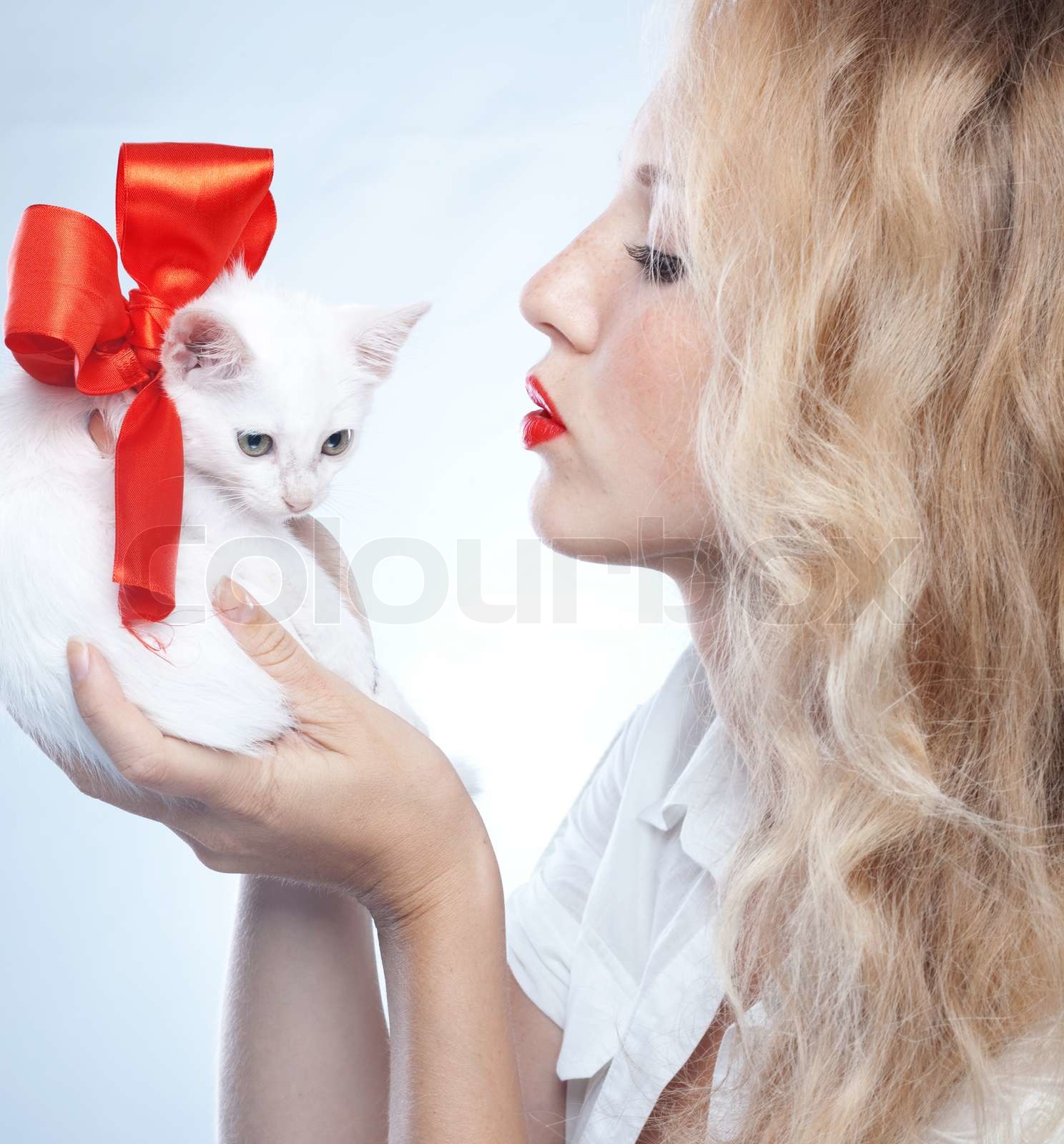 Retro styled portrait of pin-up girl with kitten | Stock image | Colourbox