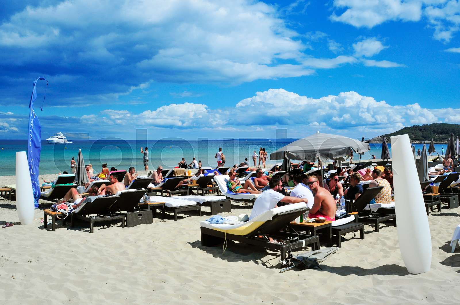 sunbathers in Platja den Bossa beach in Ibiza Town, Spain | Stock image ...