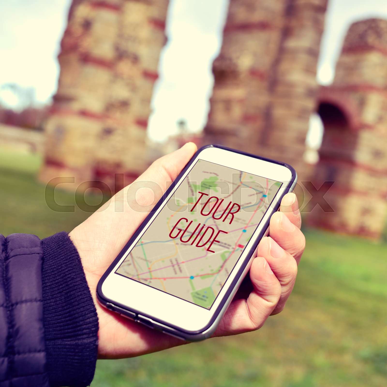 man with a smartphone with the text tour guide - Stock Image - Everypixel