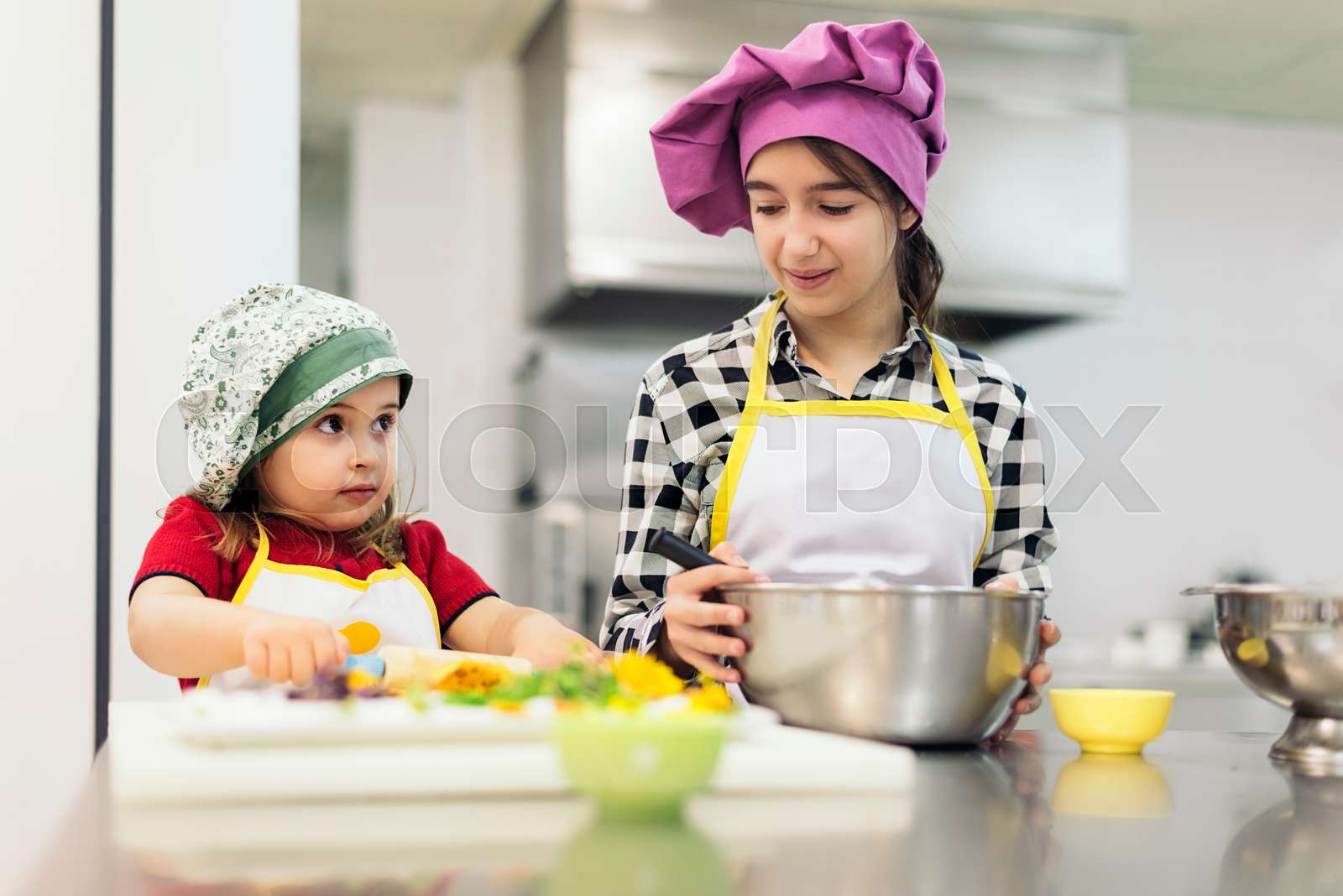 Happy girl cooking in a kitchen. | Stock image | Colourbox