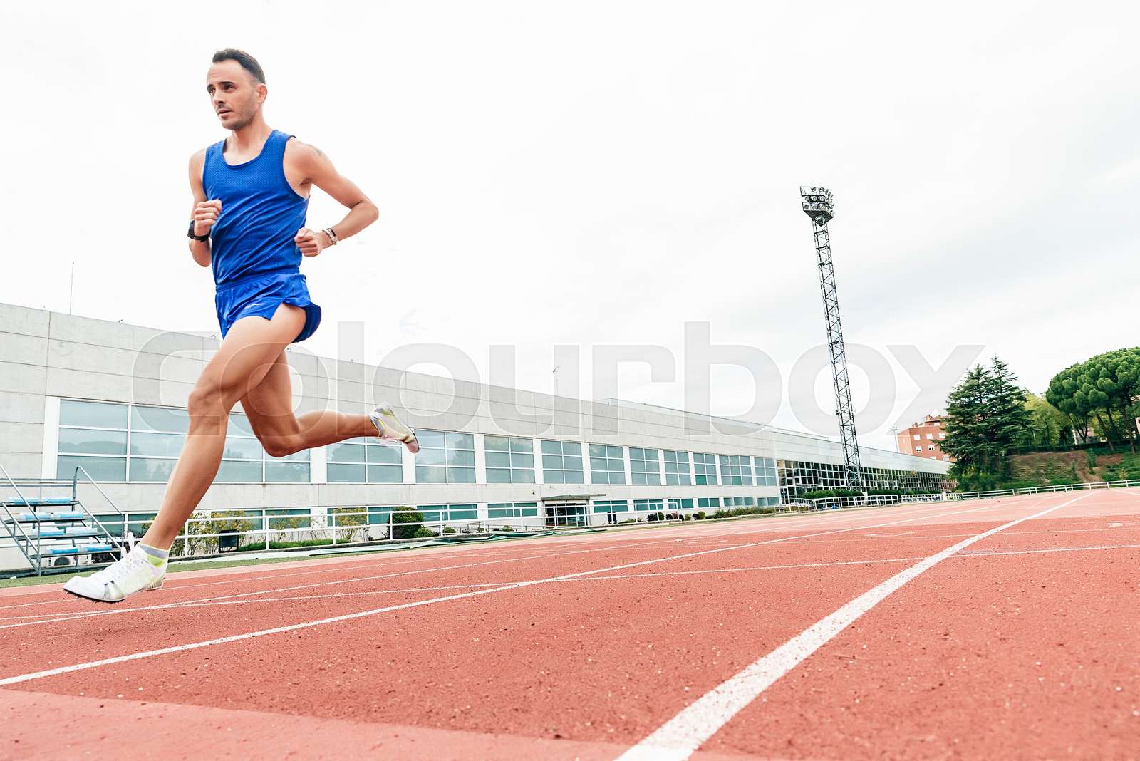 Attractive man Track Athlete Running On Track | Stock image | Colourbox