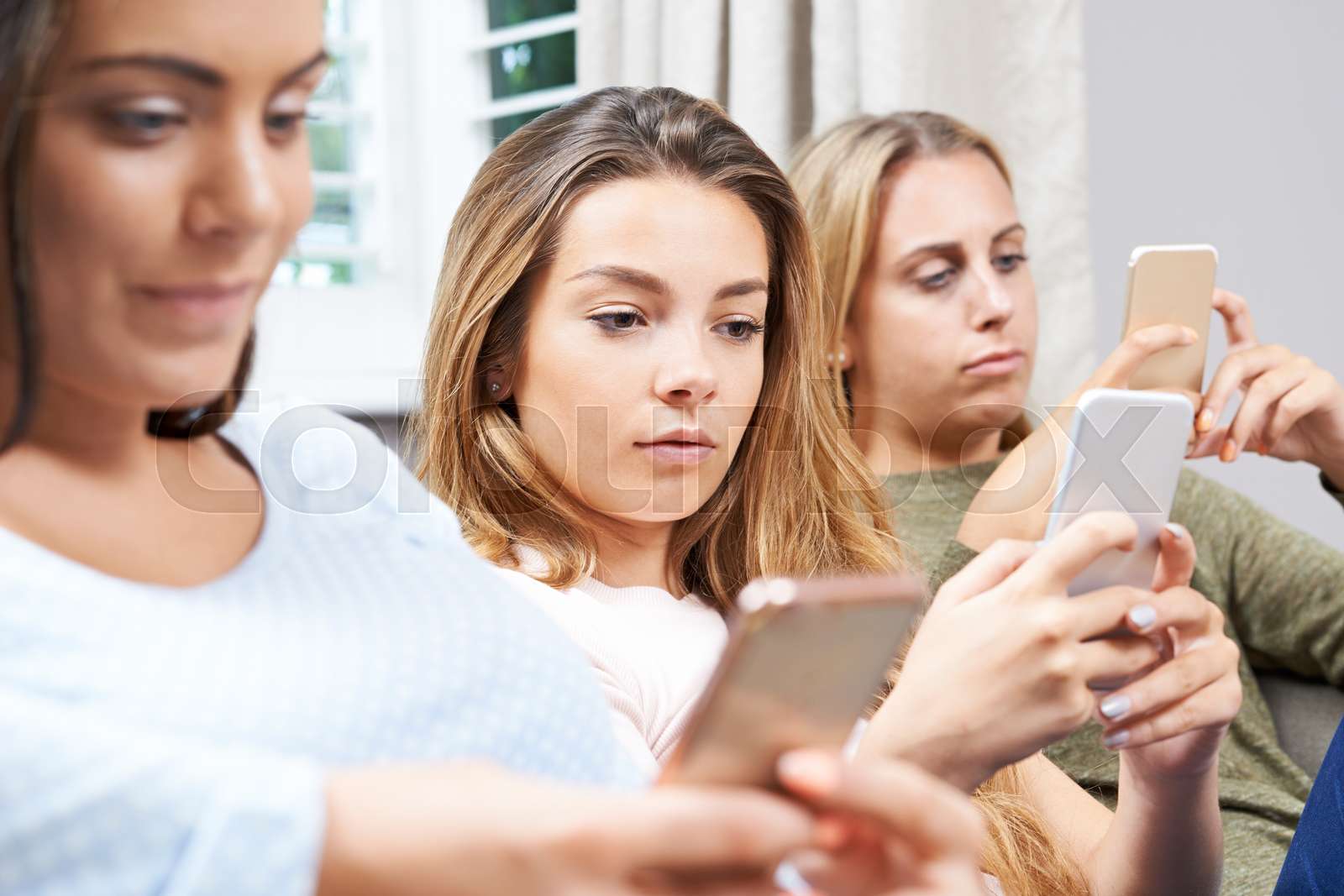 Group Of Teenage Girls Using Mobile Phones At Home | Stock image ...