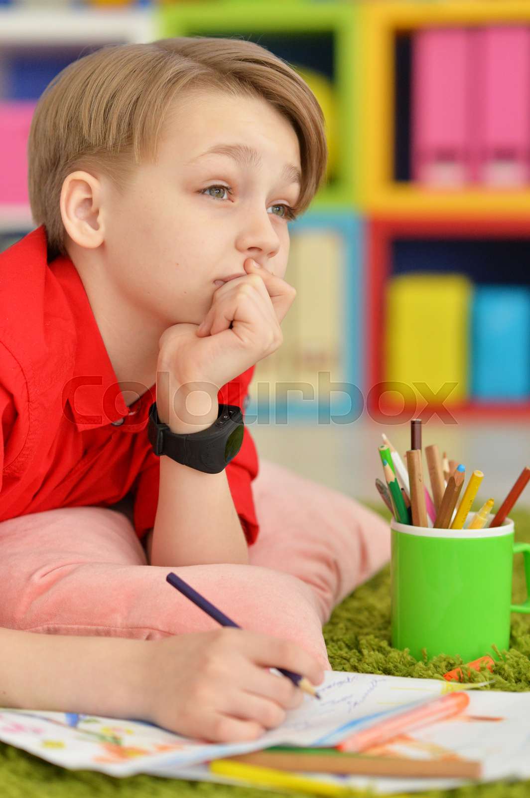 Cute boy drawing with pencils | Stock image | Colourbox