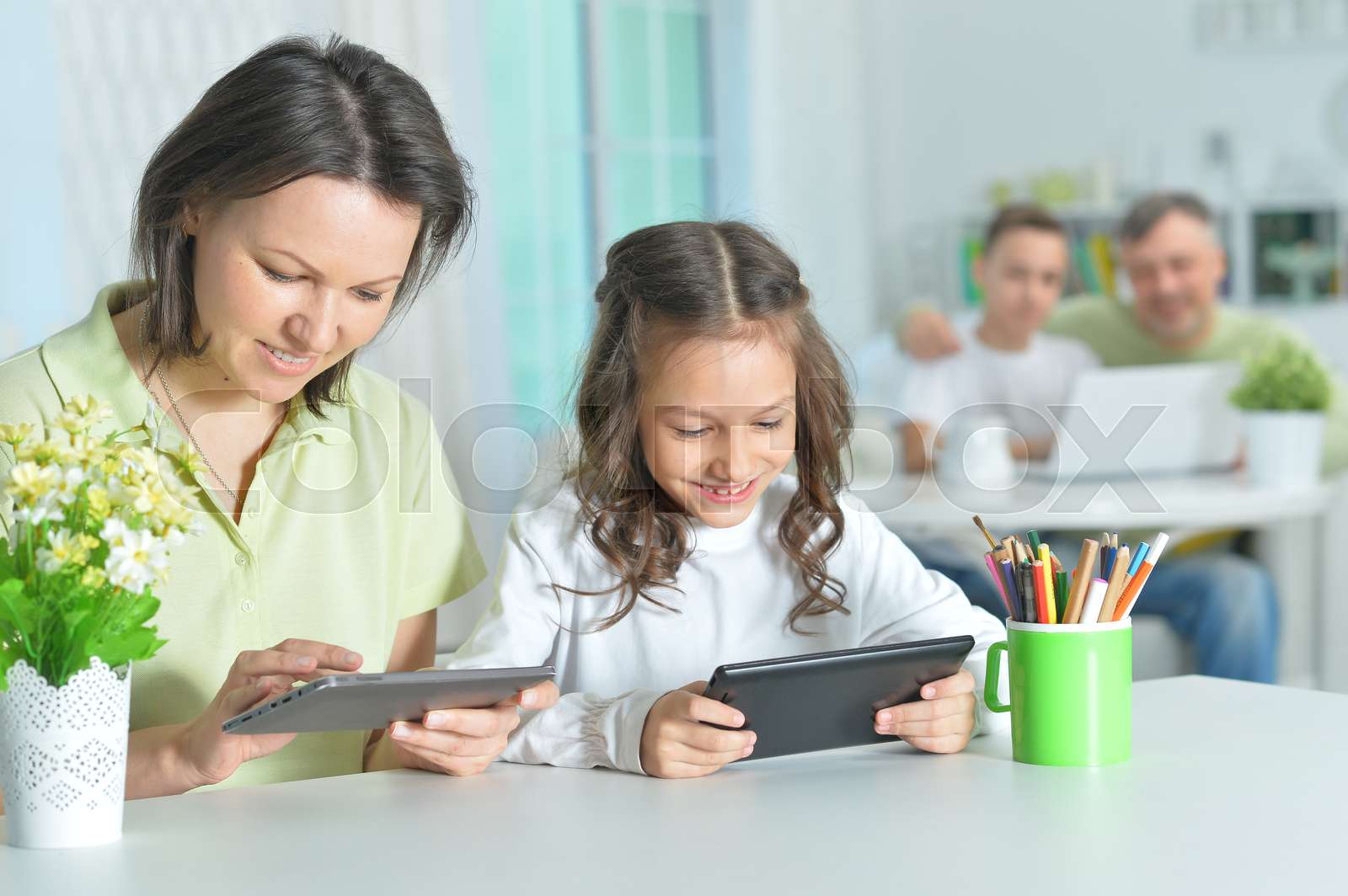 Mother And Daughter Using Tablets Stock Image Colourbox