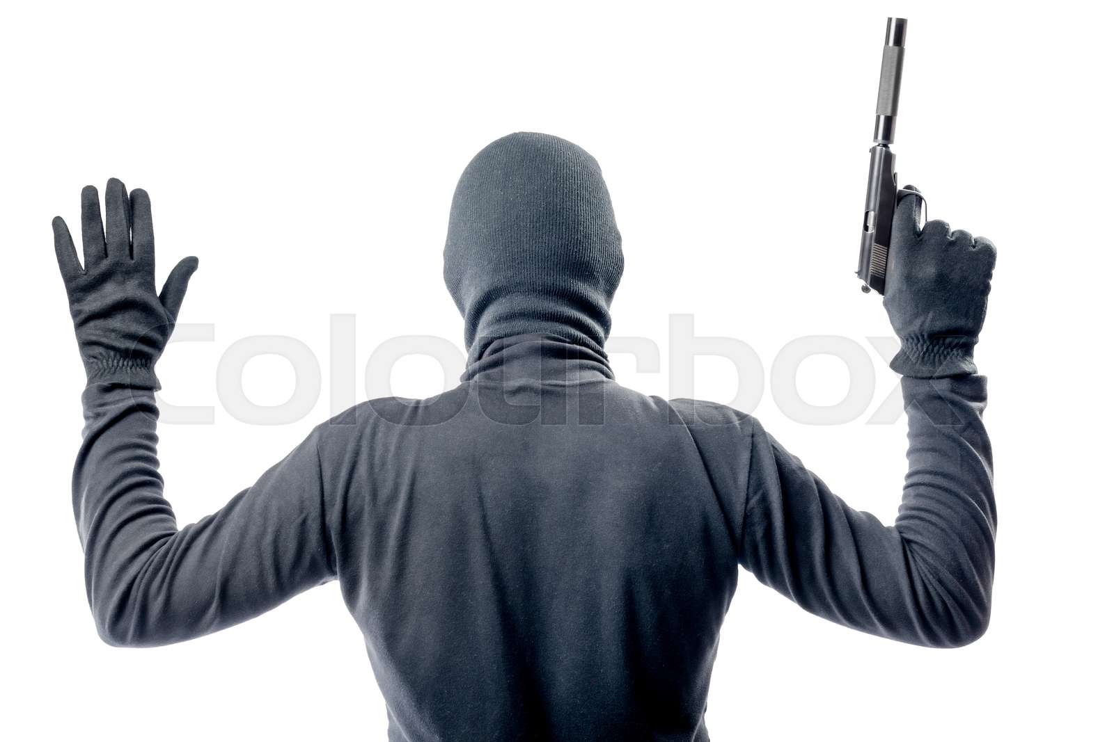 Criminal with a pistol in a balaclava raised his hands up with a gun ...