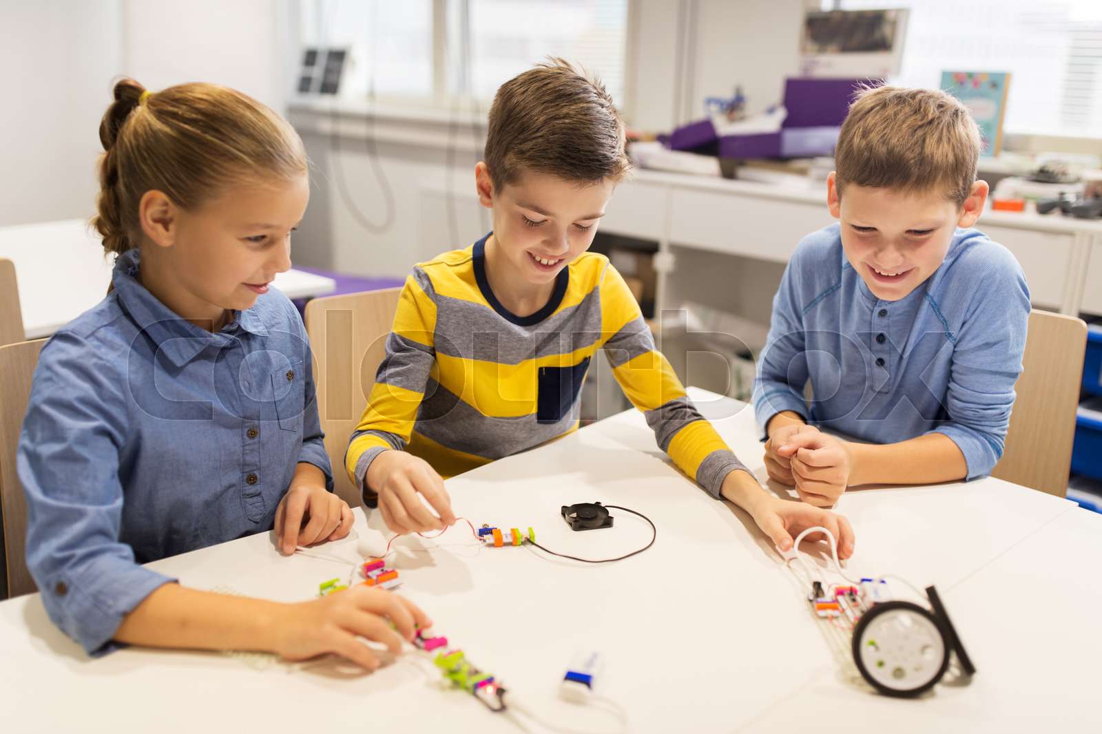 happy children building robots at robotics school | Stock image | Colourbox