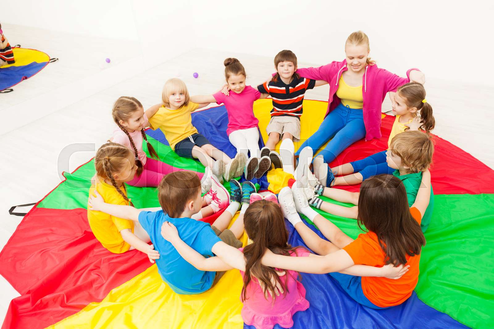 Happy children playing circle games with teacher | Stock image | Colourbox