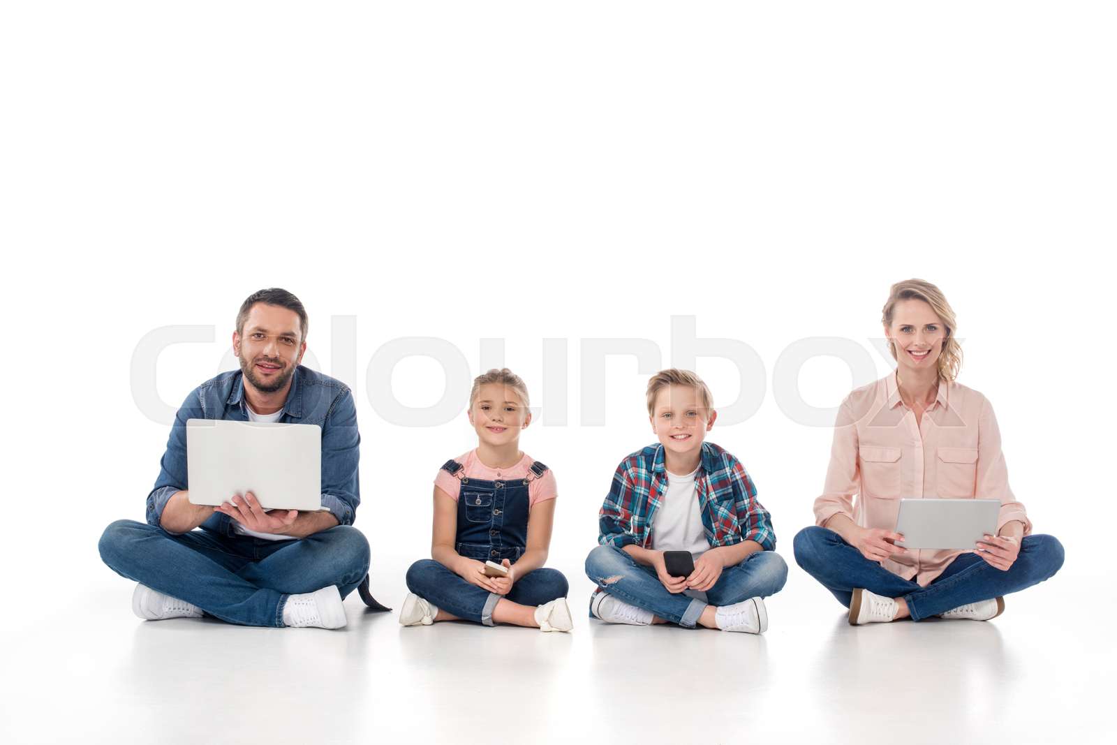 happy family using smartphones, digital tablet and laptop isolated on ...