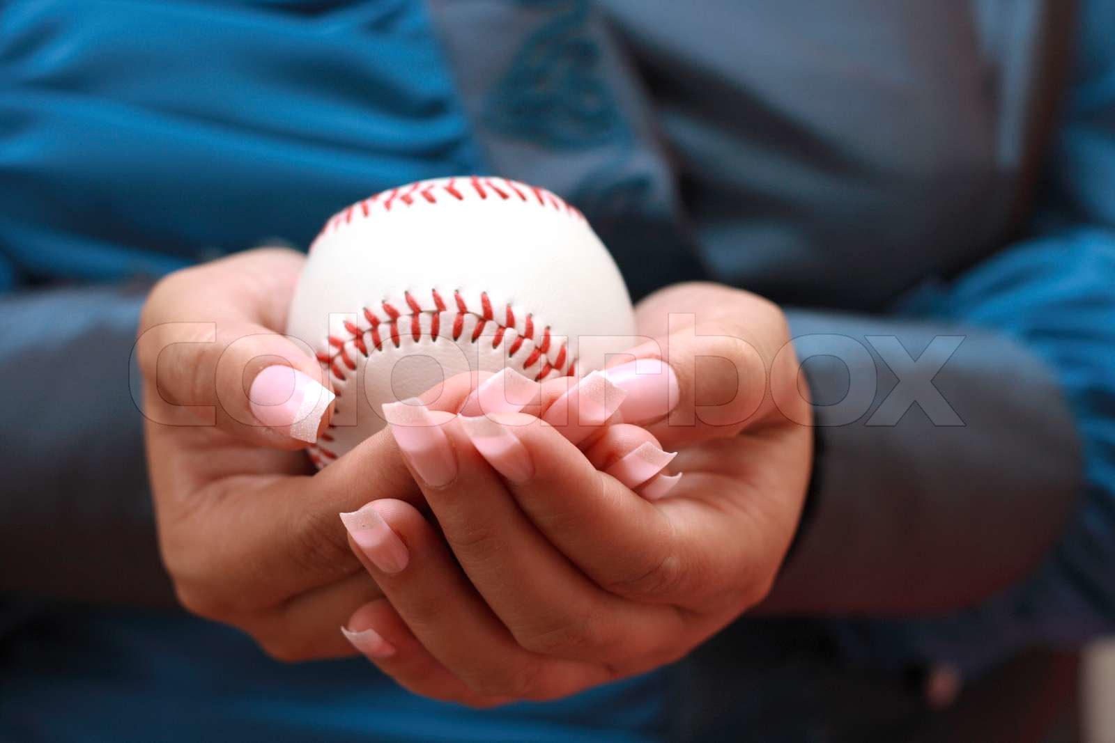 baseball in woman hand | Stock image | Colourbox