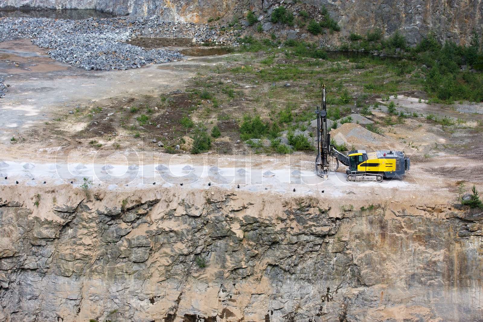 Drilling machine in open cast mining quarry | Stock image | Colourbox