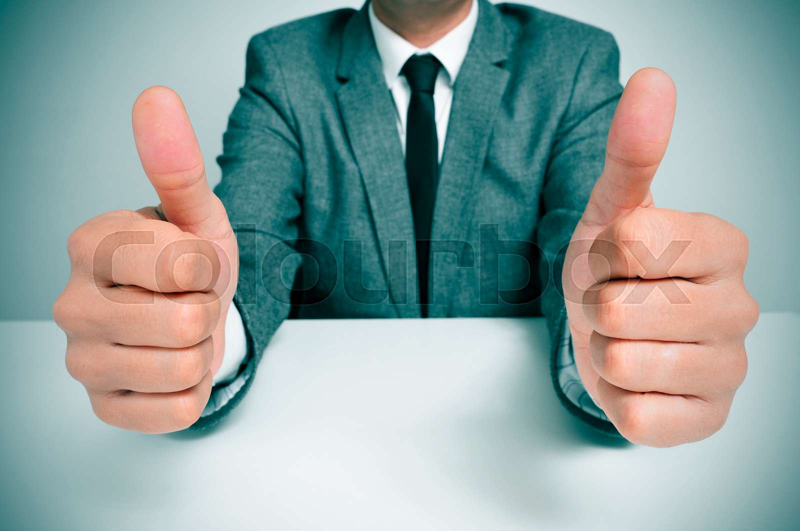 man in suit giving a thumbs up signal | Stock image | Colourbox