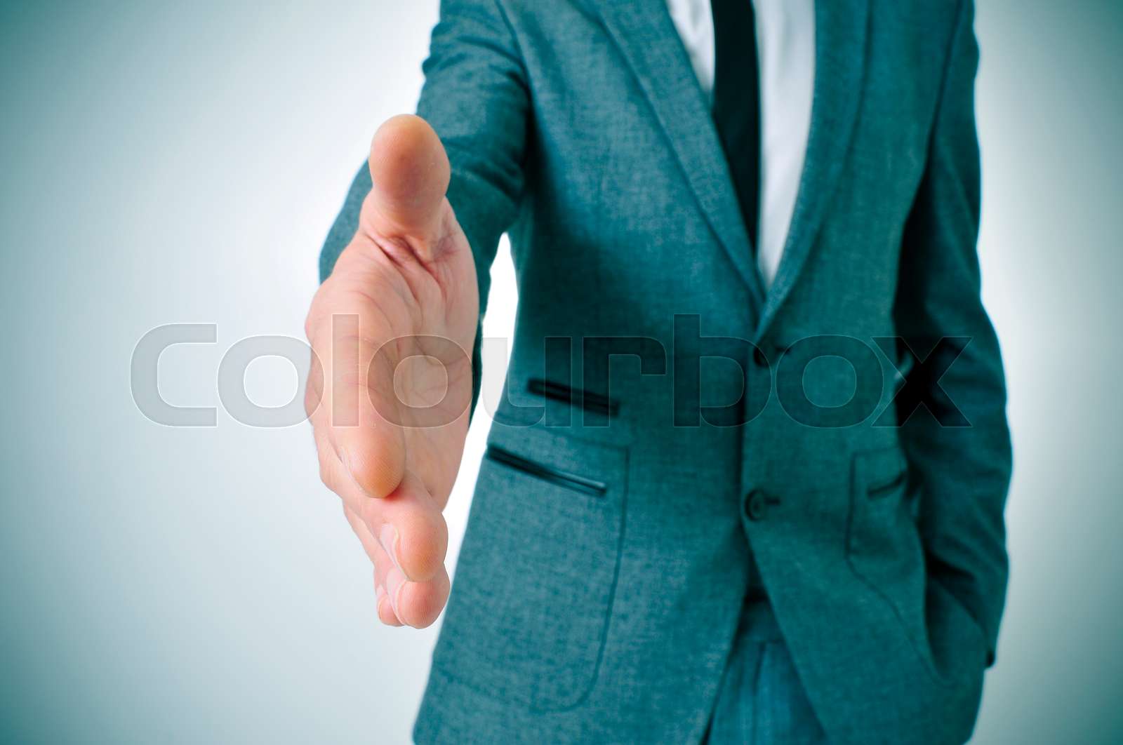man in suit offering to shake hands | Stock image | Colourbox
