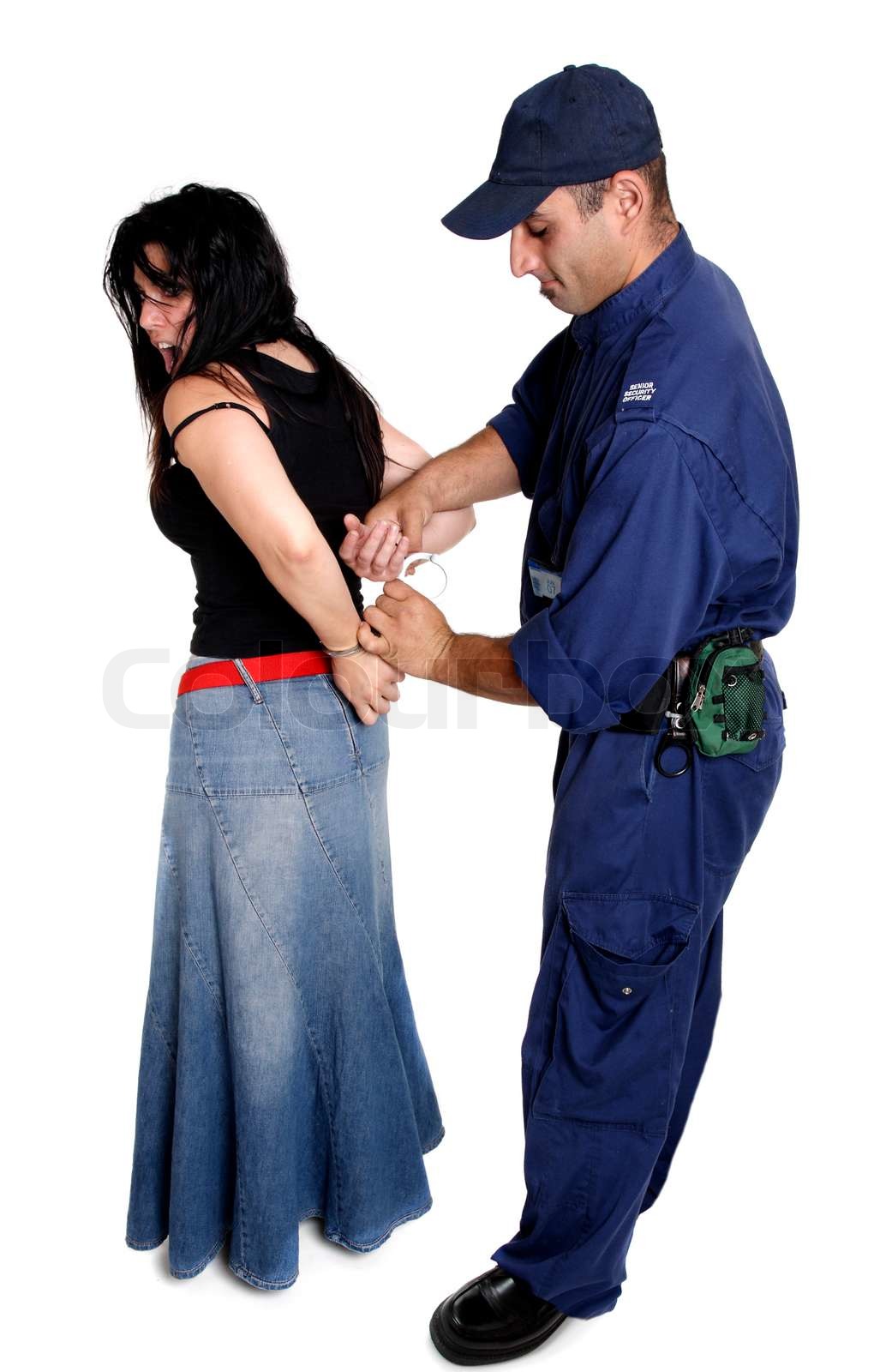 A security officer apprehends and handcuffs a female person | Stock ...