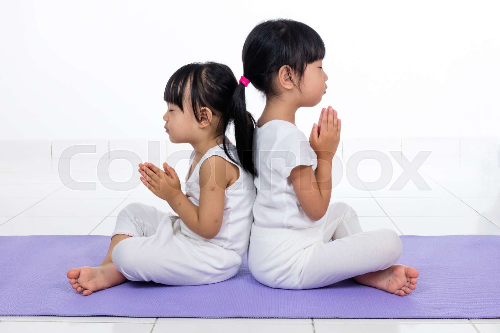 Asian Chinese little girls practicing yoga pose | Stock image | Colourbox