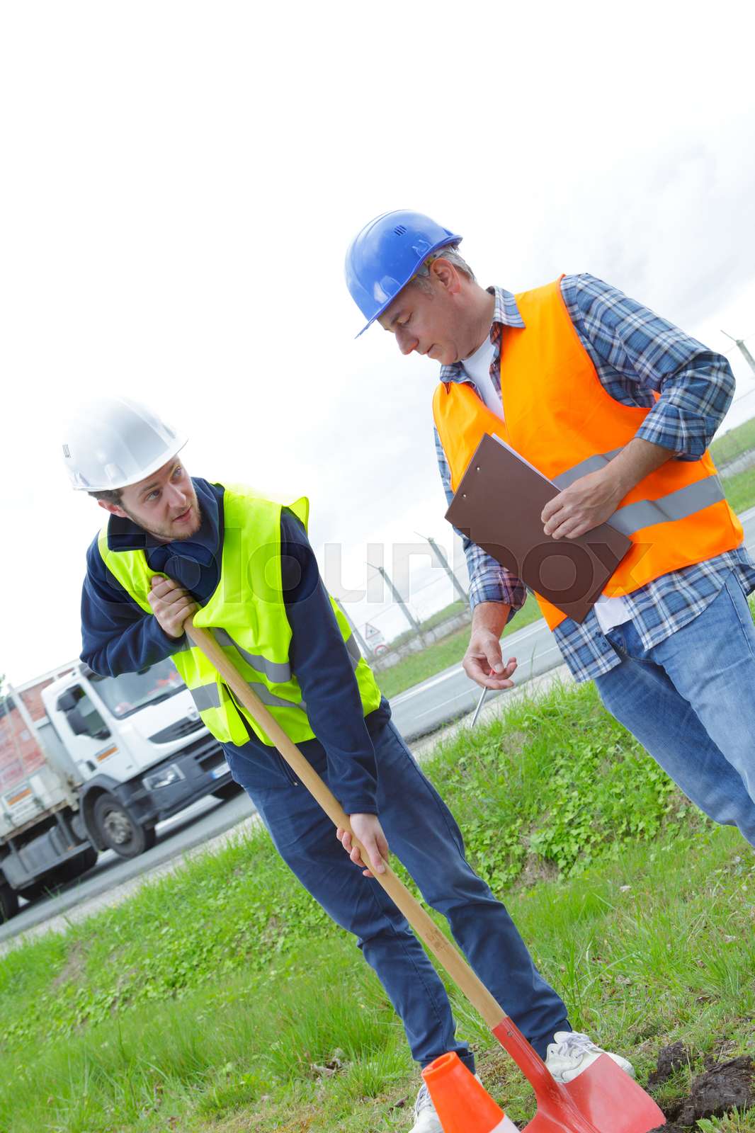 construction worker trainee digging with shovel | Stock image | Colourbox
