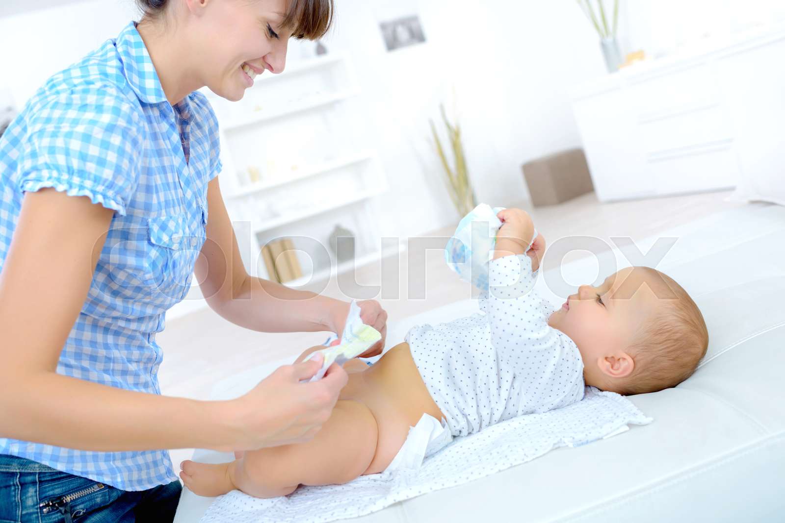 mother changing baby nappy | Stock image | Colourbox