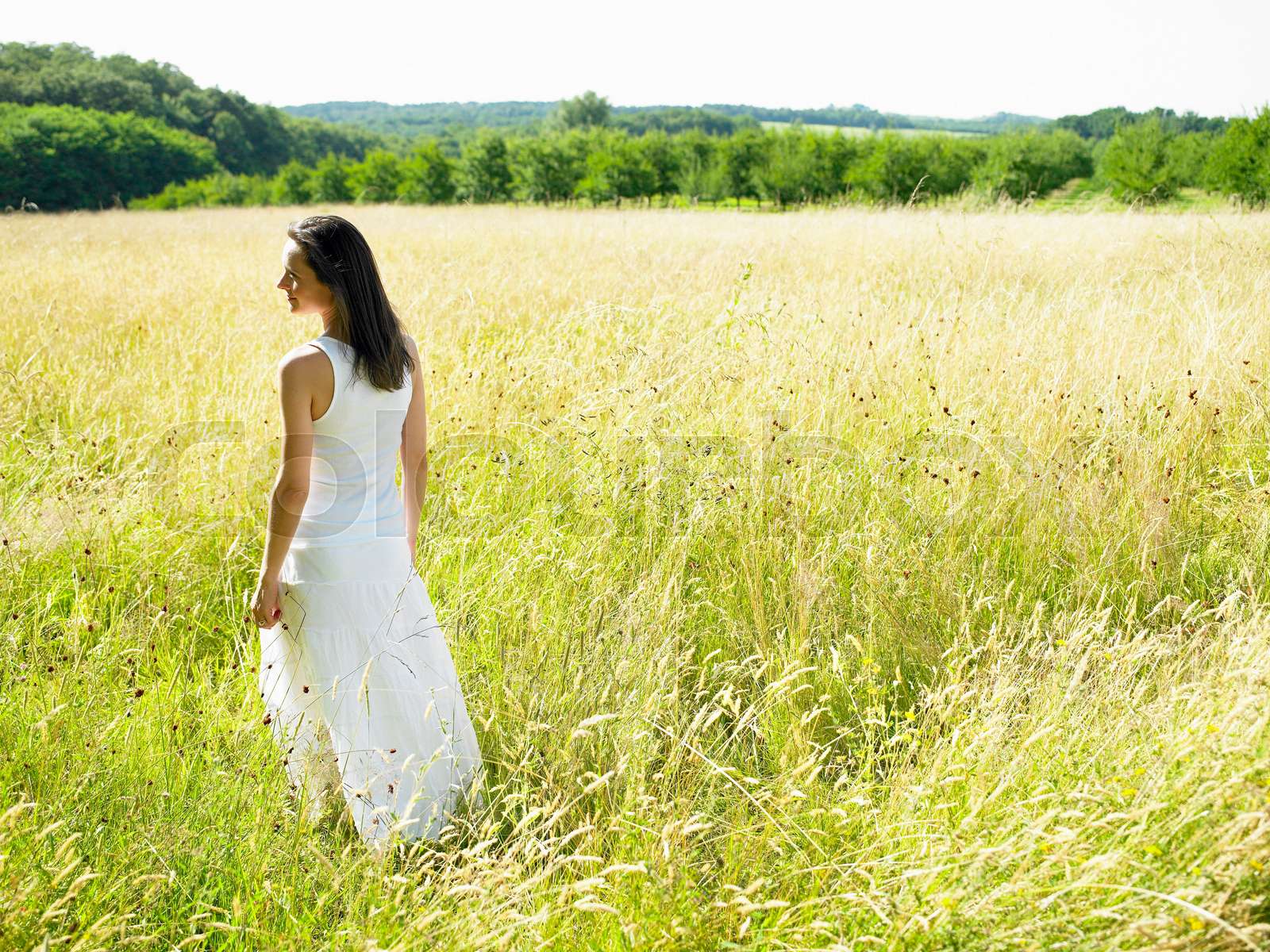 Woman walking in a field | Stock image | Colourbox