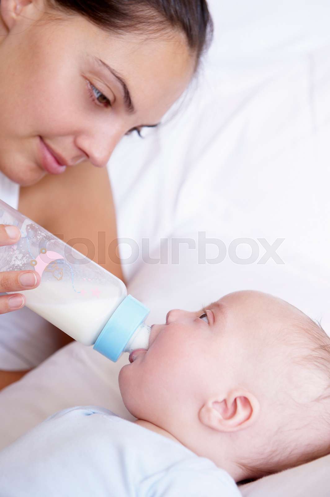 Mother giving the bottle to her baby | Stock image | Colourbox