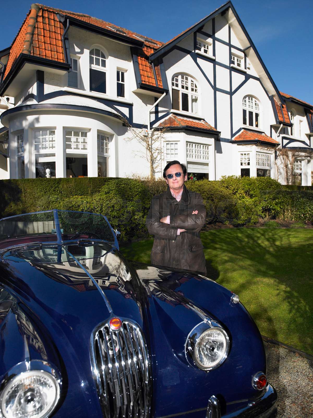 Man in front of his house and car | Stock image | Colourbox