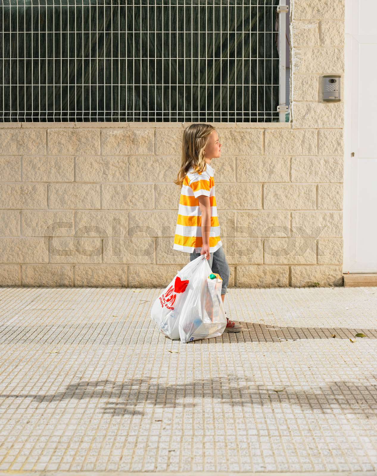 Young girl walking on pavement | Stock image | Colourbox