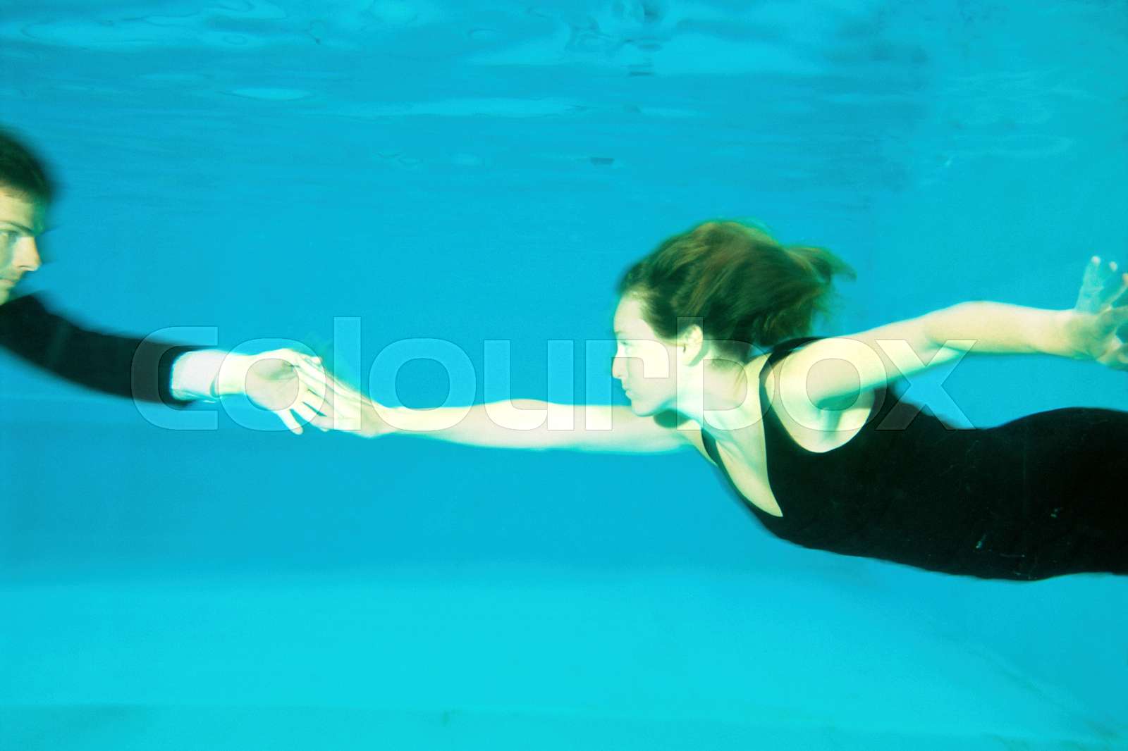 A couple dancing in a swimming pool | Stock image | Colourbox