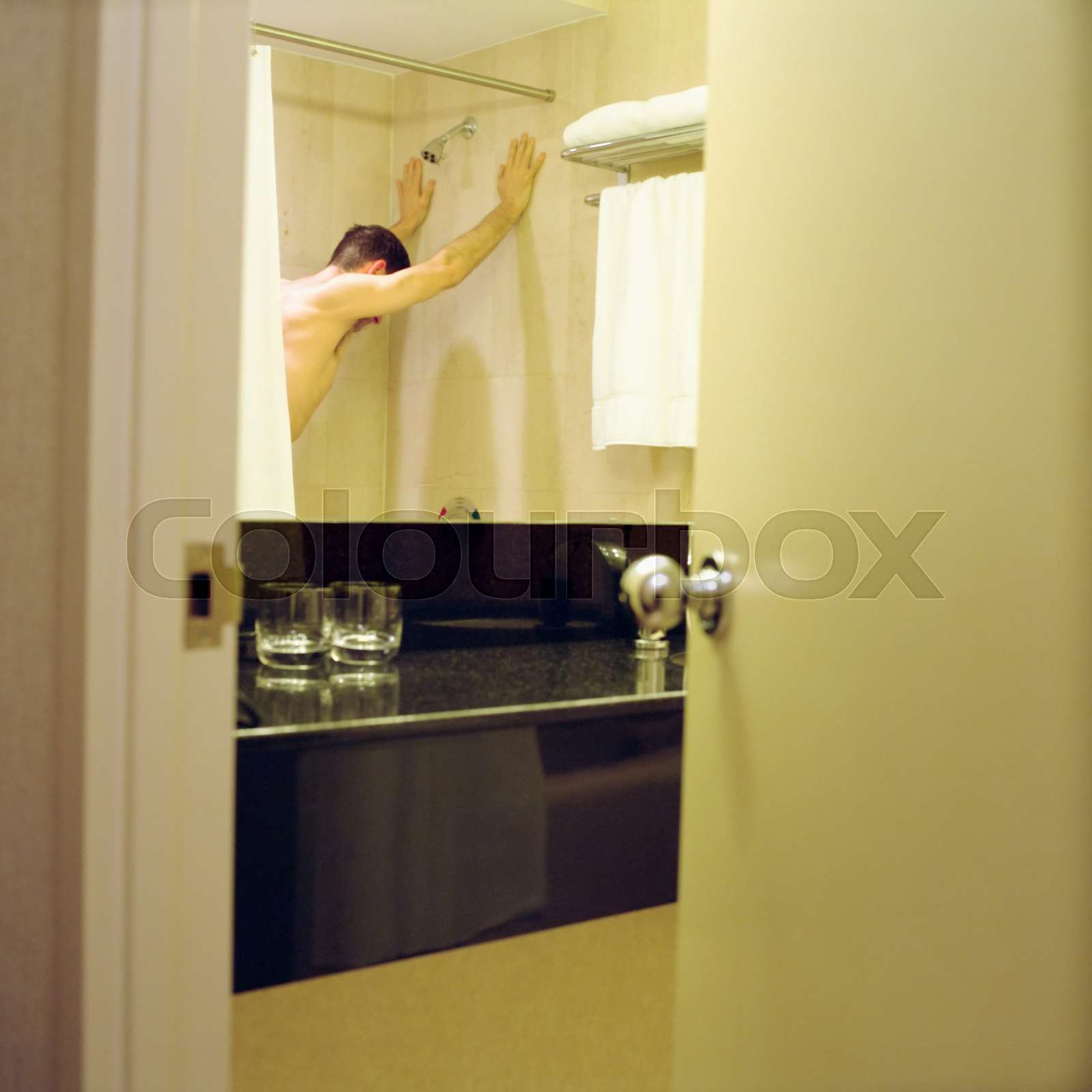 Man standing in shower | Stock image | Colourbox