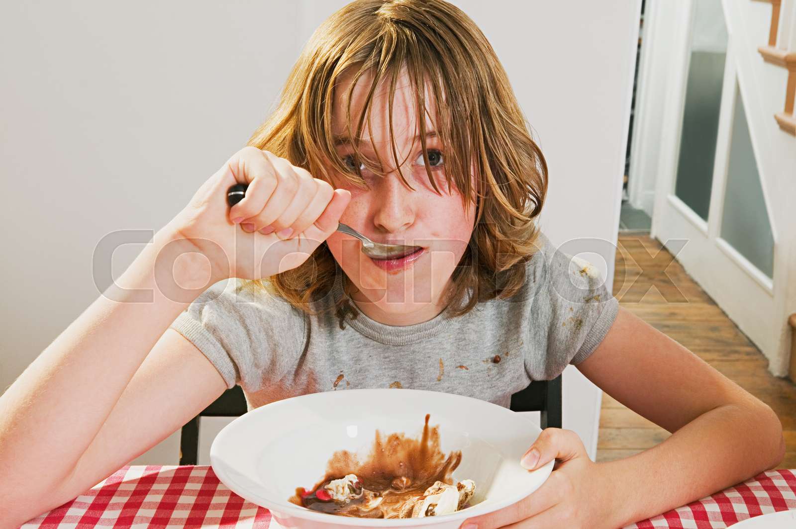Girl eating messily | Stock image | Colourbox