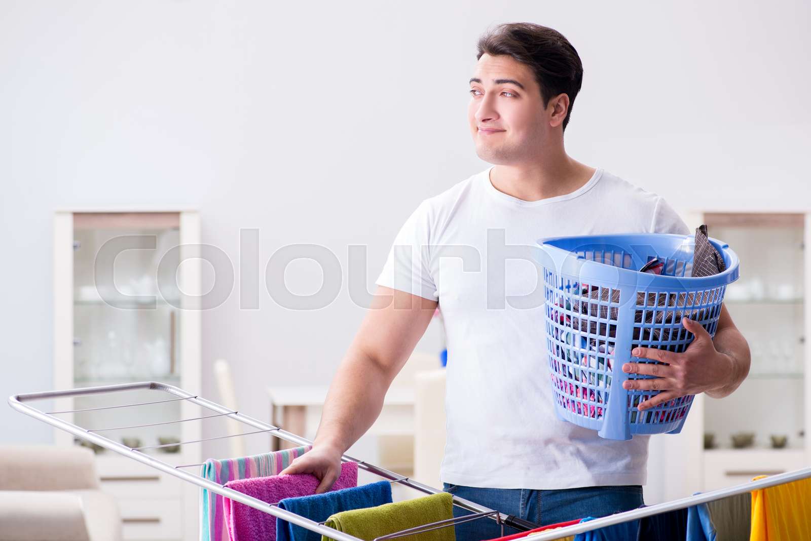 Man doing laundry at home | Stock image | Colourbox