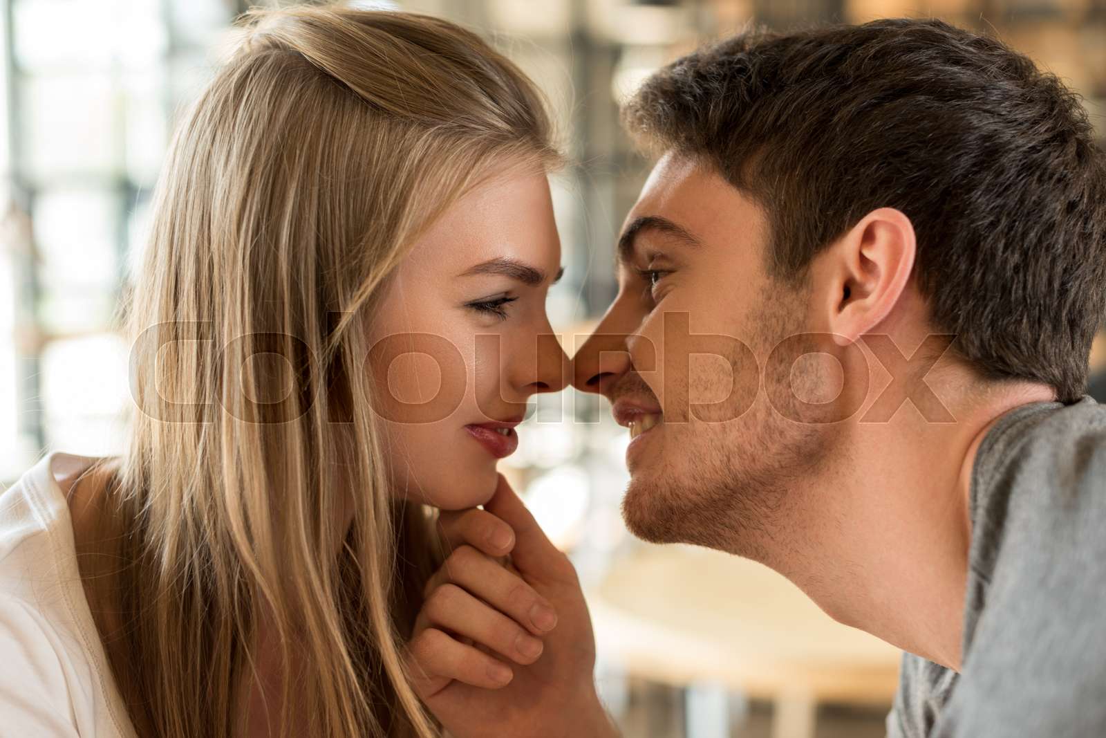 side view of young man kissing beautiful girlfriend | Stock image ...
