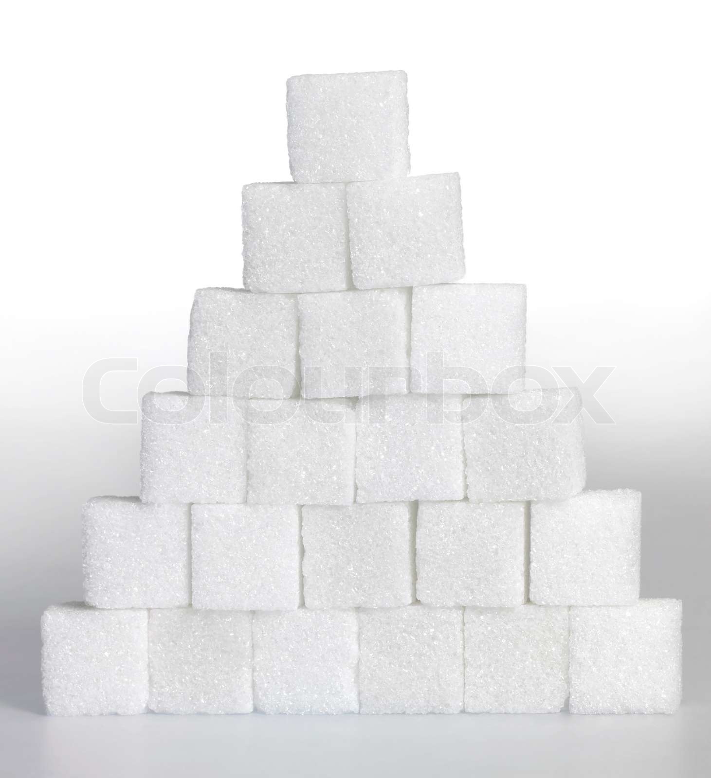 Studio photography of a pyramid made of lump sugar pieces in light ...