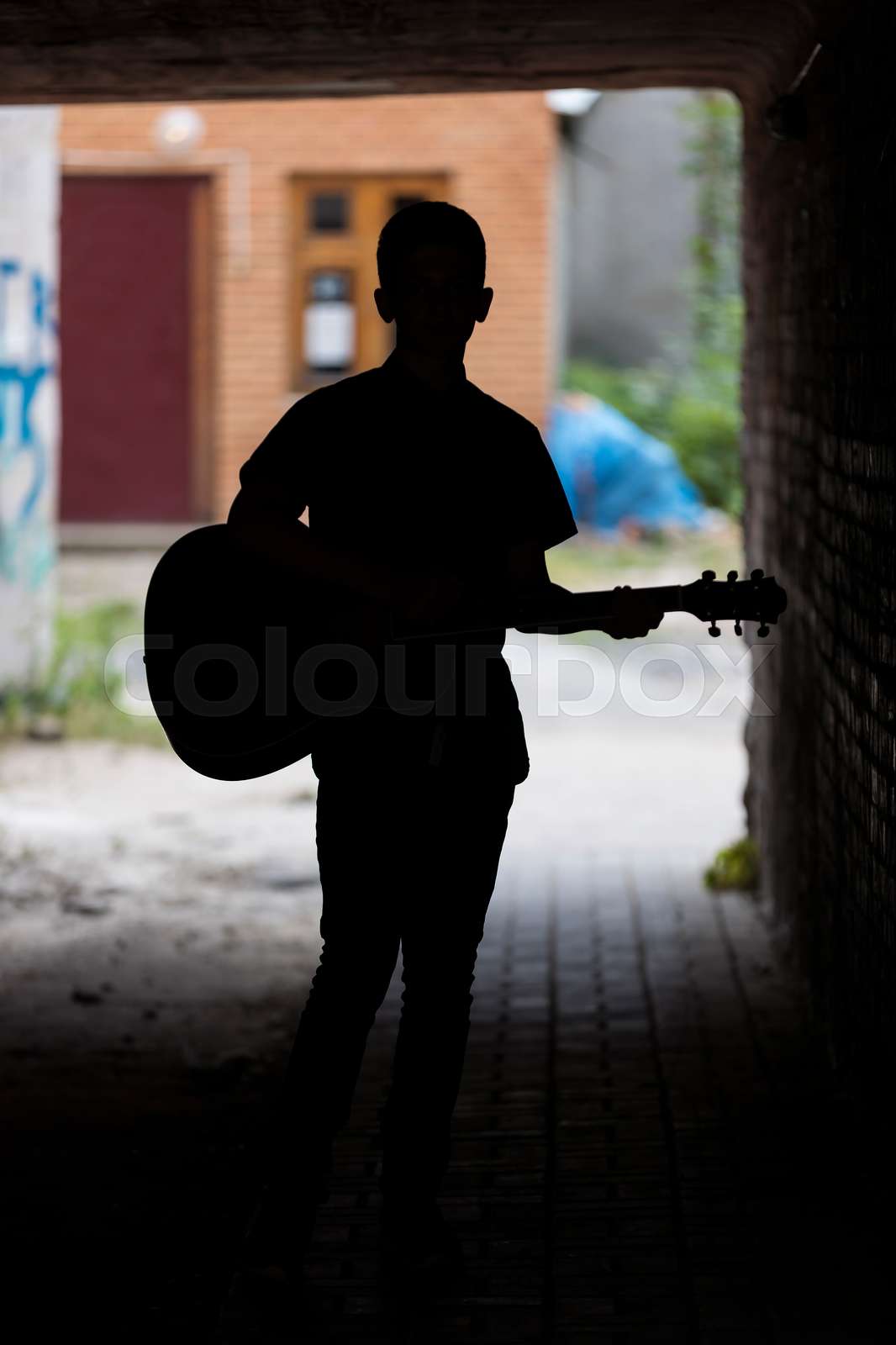 Young sad guy with an acoustic guitar | Stock image | Colourbox
