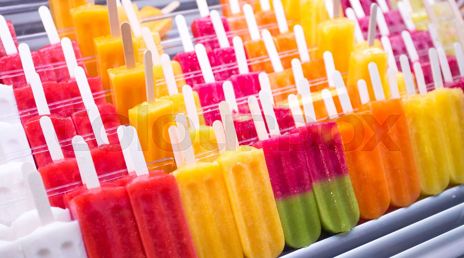assortment of colorful popsicles on market stall | Stock image | Colourbox