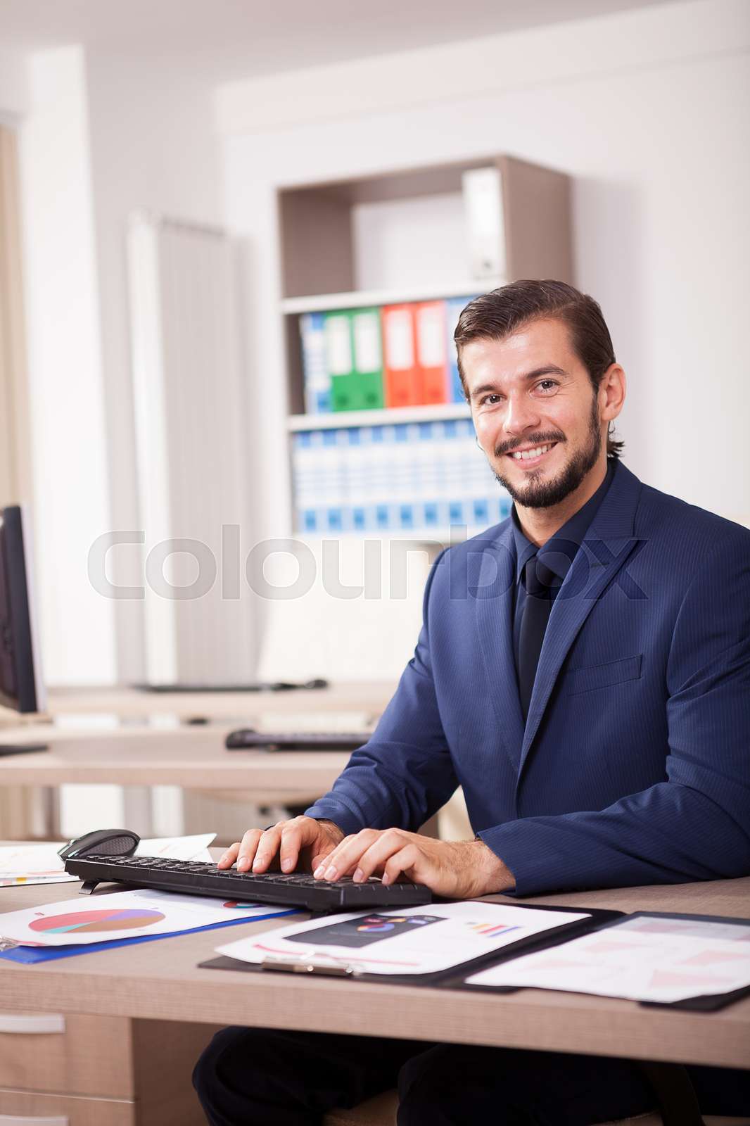 Beautiful Businessman in suit in his office | Stock image | Colourbox