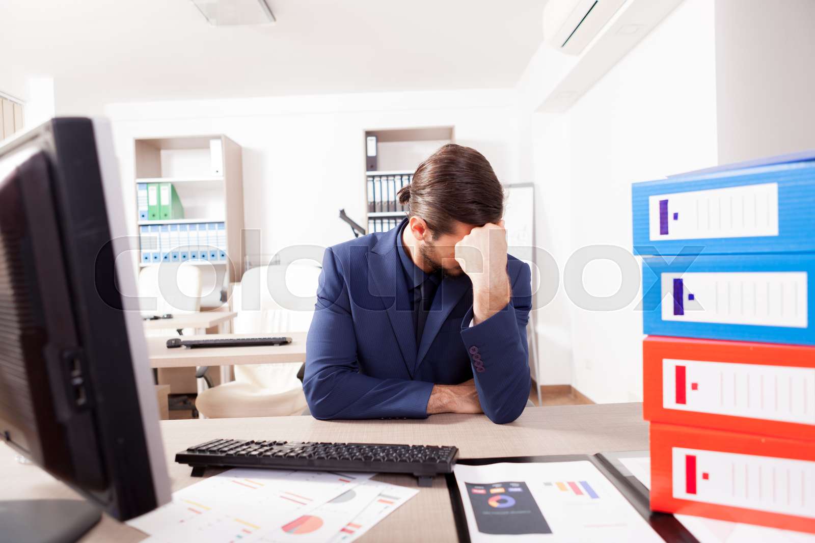 Young corporate worker depressed from the workload | Stock image ...