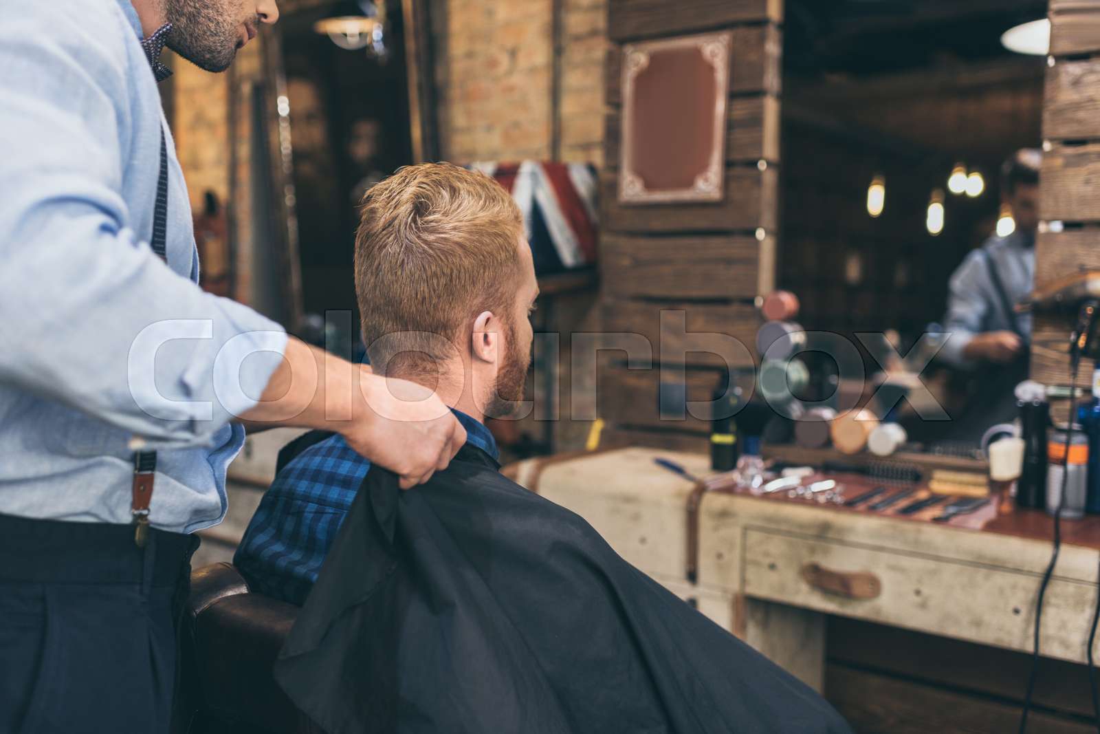 barber with customer in barber shop | Stock image | Colourbox