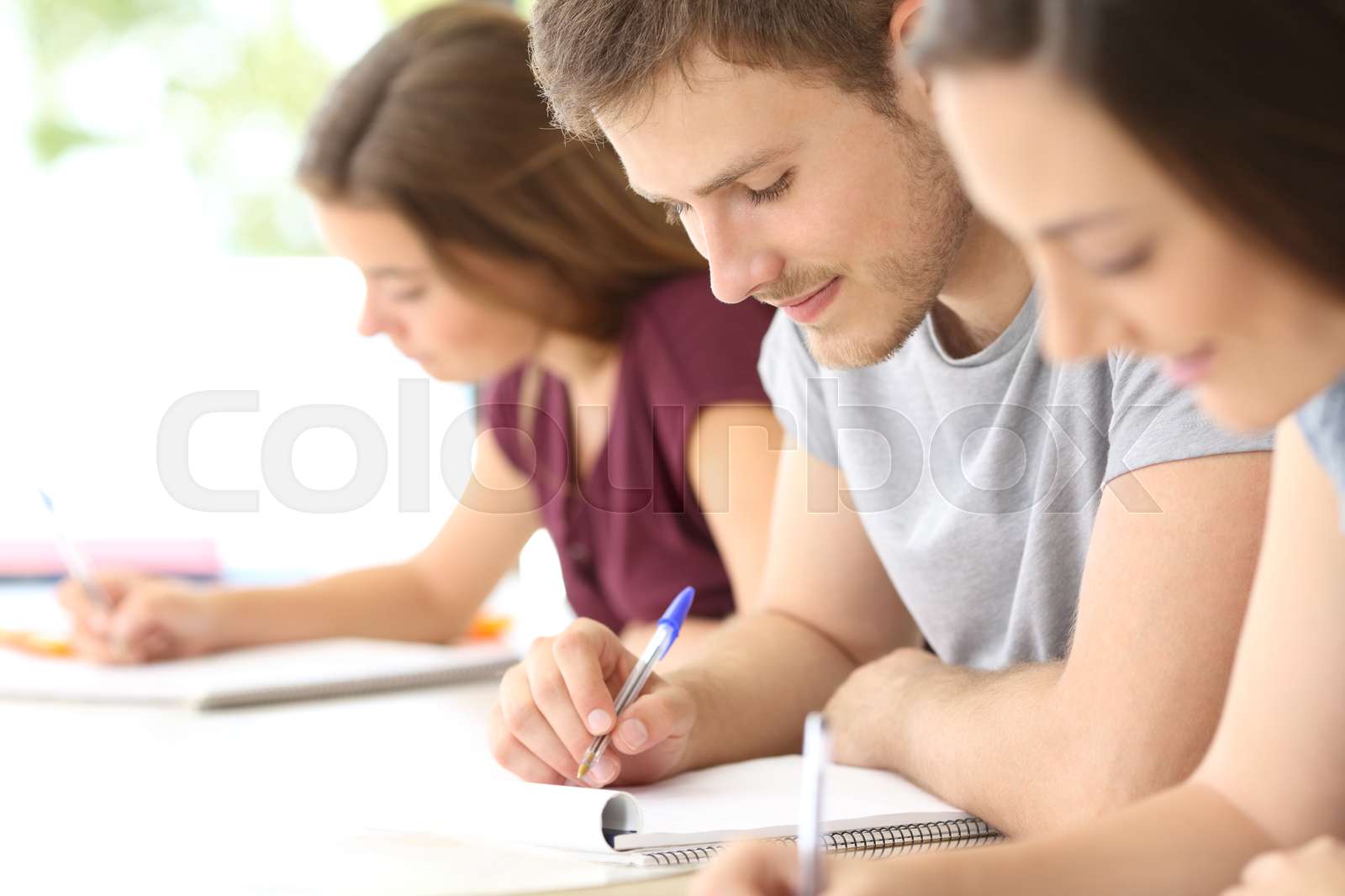 Close up of students taking notes at classroom | Stock image | Colourbox