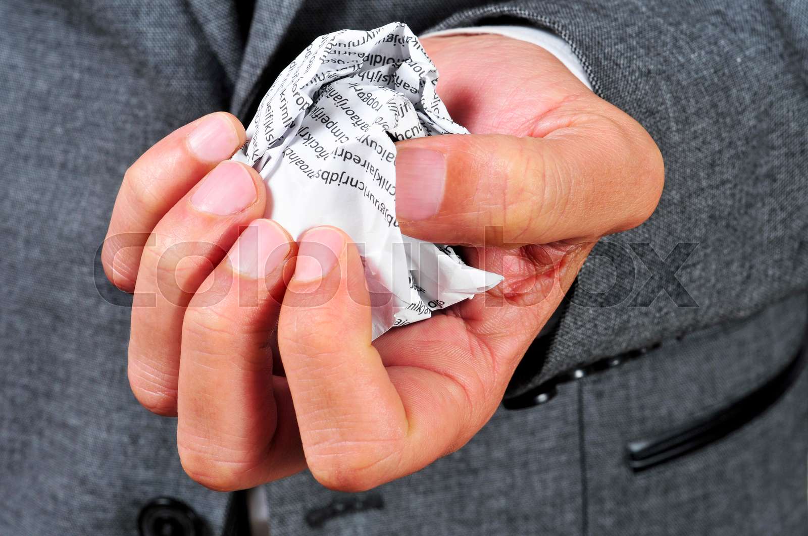 man in suit with a crumpled piece of paper | Stock image | Colourbox