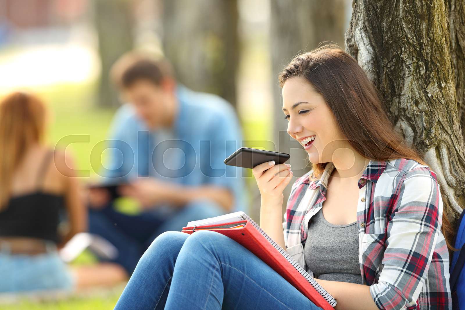 Student using voice recognition with a phone | Stock image | Colourbox