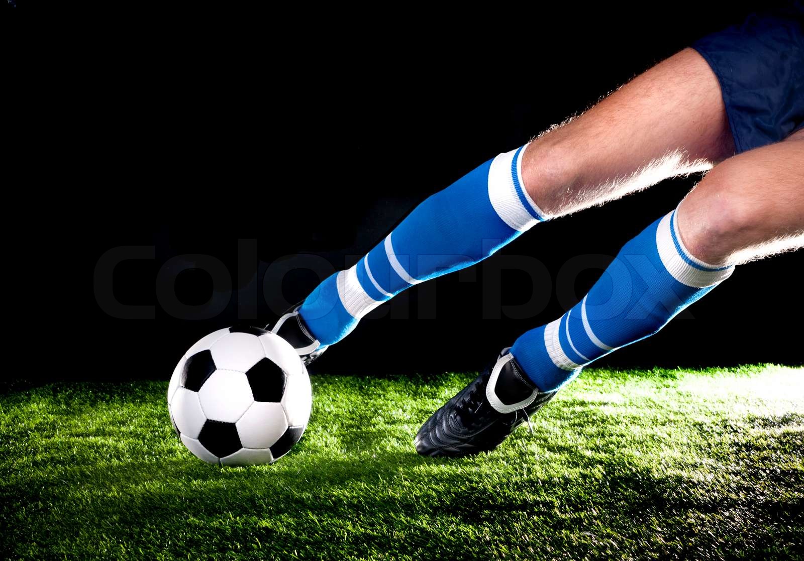 player hits the ball with his foot on the football field | Stock image ...