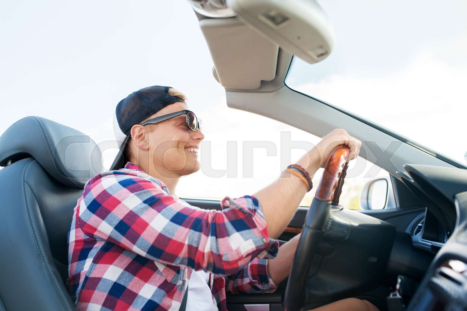 happy young man driving convertible car | Stock image | Colourbox